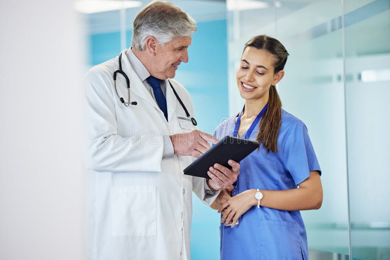 Take Every Opportunity To Learn. Two Doctors Using a Digital Tablet ...