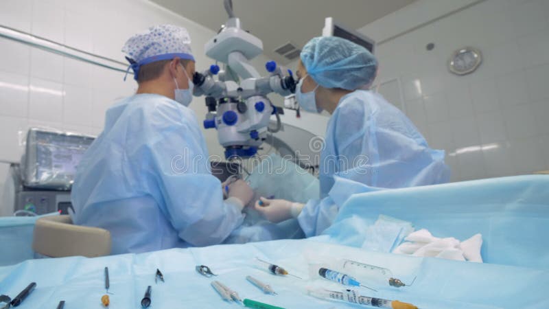 Two Doctors Using an Ophthalmic Surgical Microscope Together. Stock ...