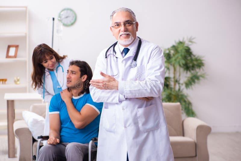 Two Doctors Visiting Sick Young Man at Home Stock Image - Image of ...