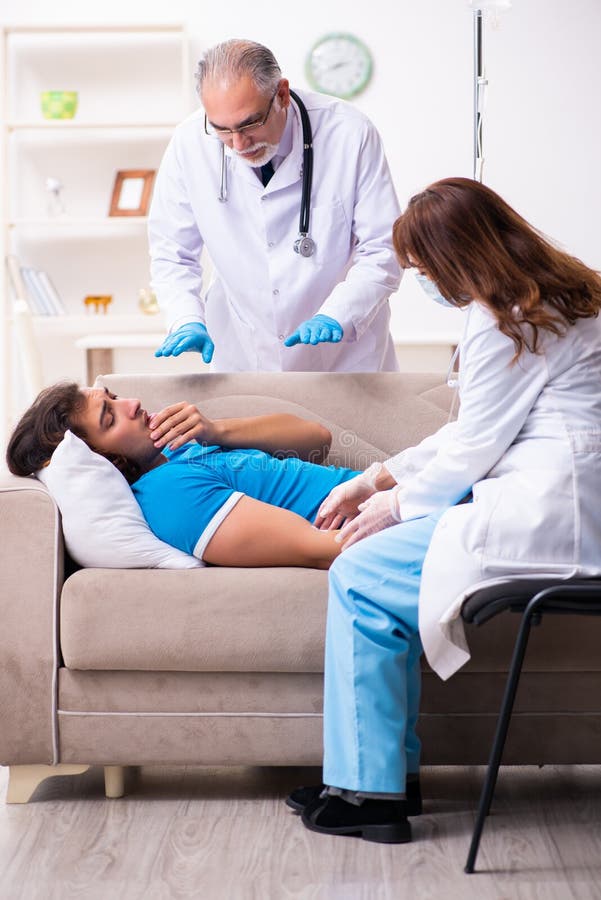 Two Doctors Visiting Sick Young Man at Home Stock Image - Image of pole ...