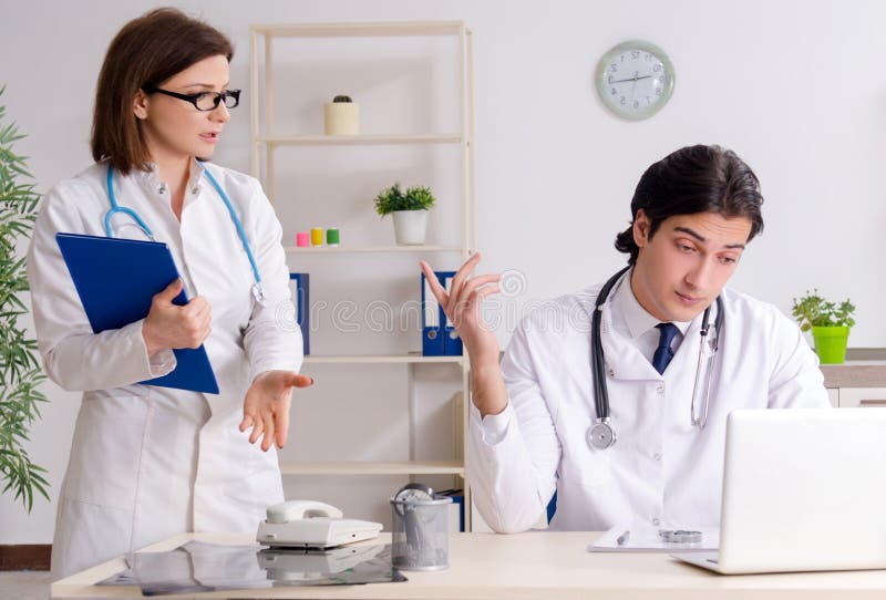 Two Doctors Working in the Clinic Stock Photo - Image of clinic ...