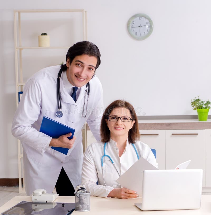 Two Doctors Working in the Clinic Stock Photo - Image of care ...