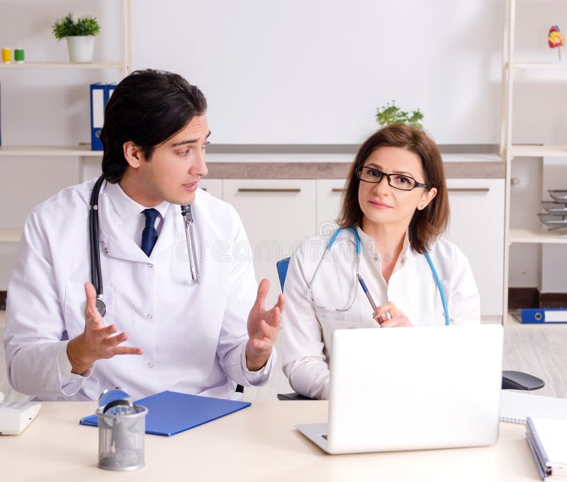 Two Doctors Working in the Clinic Stock Photo - Image of examining ...