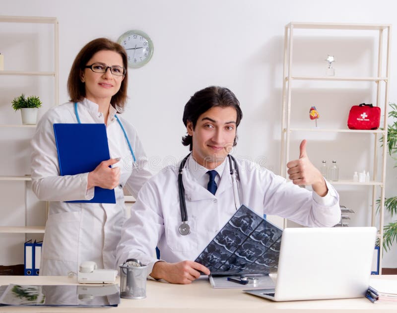 Two Doctors Working in the Clinic Stock Photo - Image of discussing ...