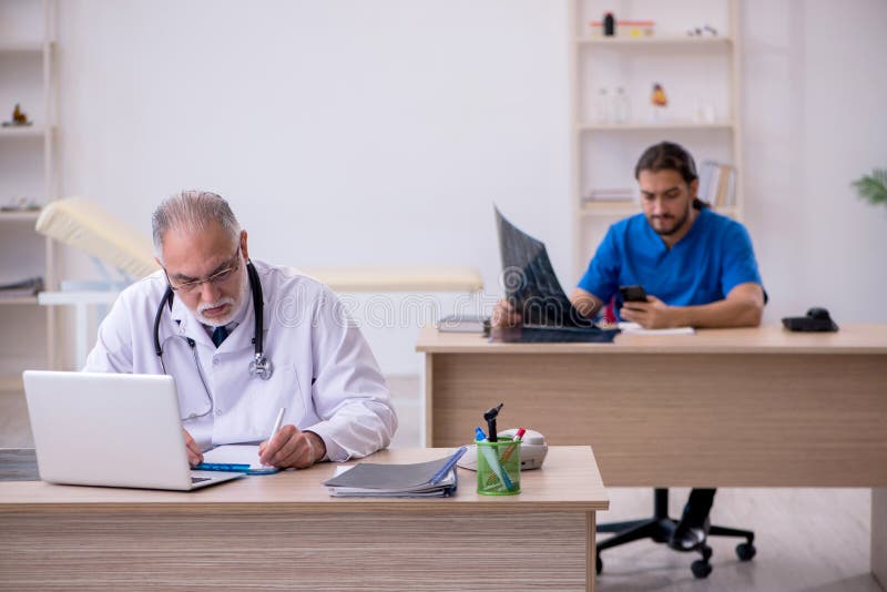 Two Doctors Working in the Clinic Stock Image - Image of discussing ...