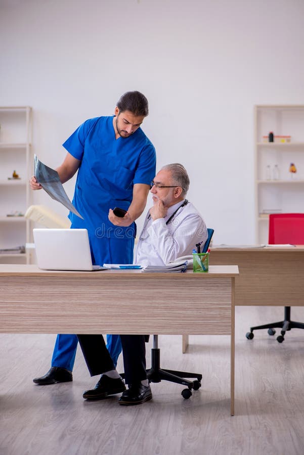 Two Doctors Working in the Clinic Stock Image - Image of intern ...