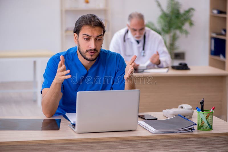 Two Doctors Working in the Clinic Stock Image - Image of doctor ...