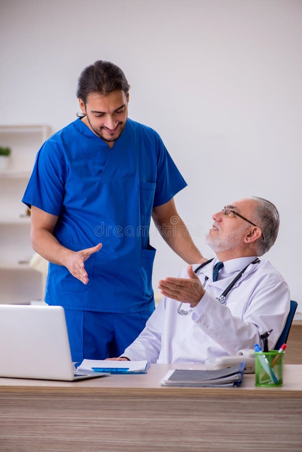 Two Doctors Working in the Clinic Stock Image - Image of care, practice ...