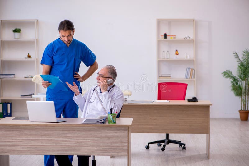 Two Doctors Working in the Clinic Stock Photo - Image of conference ...
