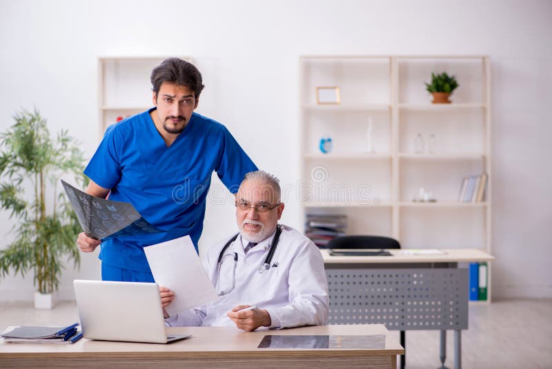 Two Male Doctors Working in the Clinic Stock Photo - Image of ...