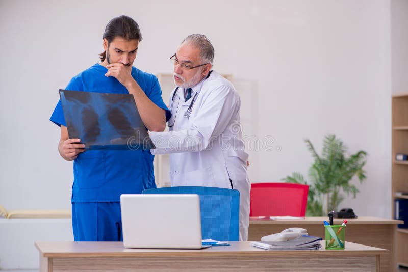 Two Doctors Working in the Clinic Stock Photo - Image of discussing ...