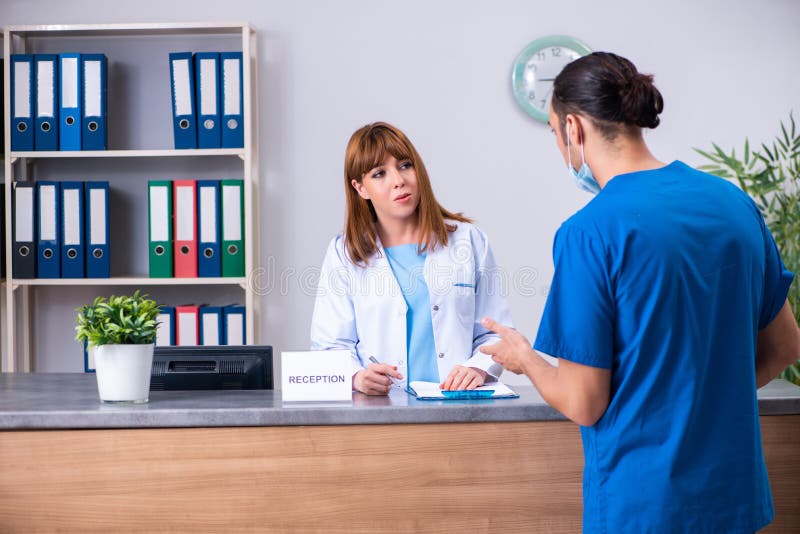Two Doctors Working at the Reception in the Hospital Stock Photo ...