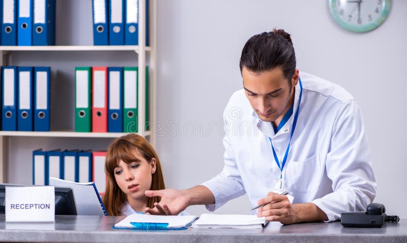 Two Doctors Working at the Reception in the Hospital Stock Image ...