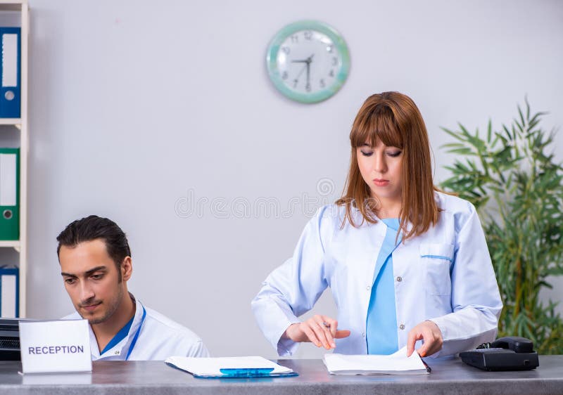 Two Doctors Working at the Reception in the Hospital Stock Image ...