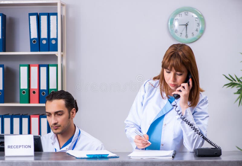 Two Doctors Working at the Reception in the Hospital Stock Image ...
