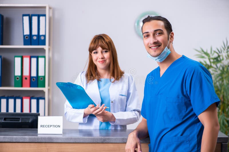 Two Doctors Working at the Reception in the Hospital Stock Image ...