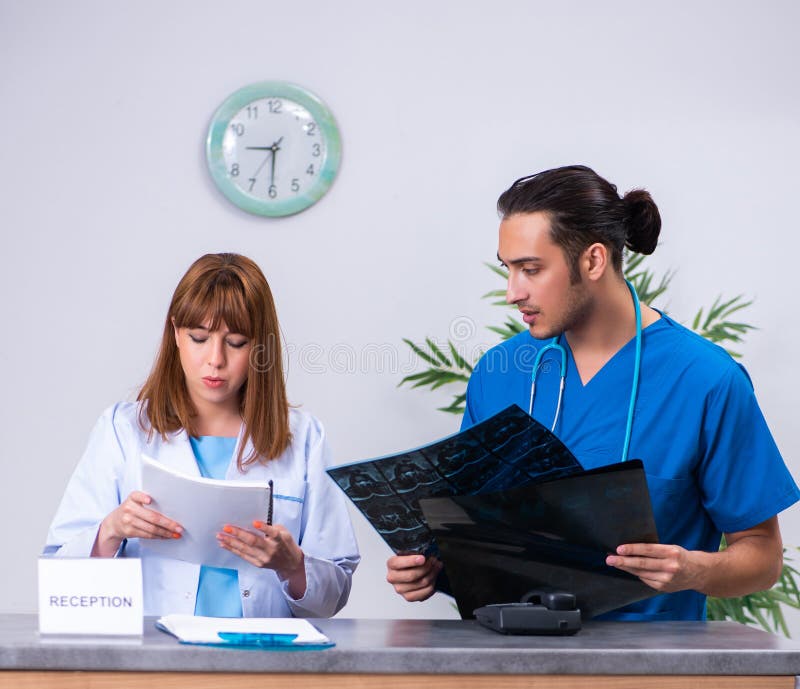 Two Doctors Working at the Reception in the Hospital Stock Photo ...