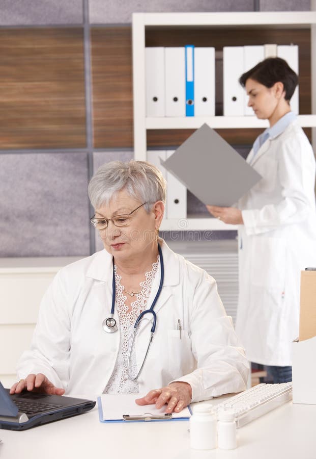 Two Doctors Working Together Stock Image - Image of boomer, experienced ...