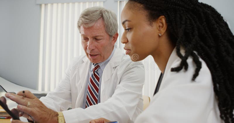 Two Doctors Working Together Stock Photo - Image of hospital, doctor ...
