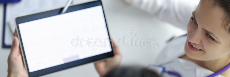 Two Doctors at Workplace are Looking at Tablet. Stock Photo - Image of ...