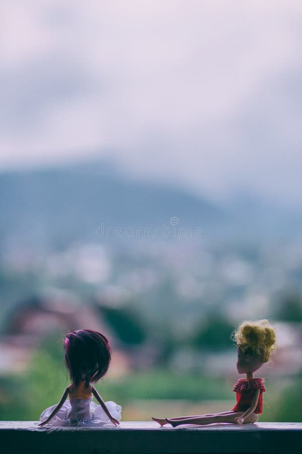 Two Dolls Sit on the Windowsill and Look into the Distance Stock Photo ...