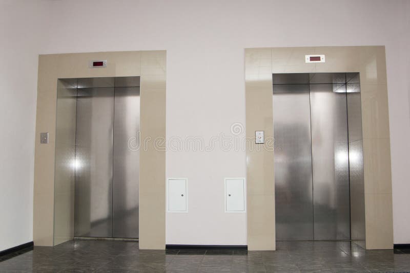 Two Elevators With Closed Metallic Doors Stock Photo - Image of ...