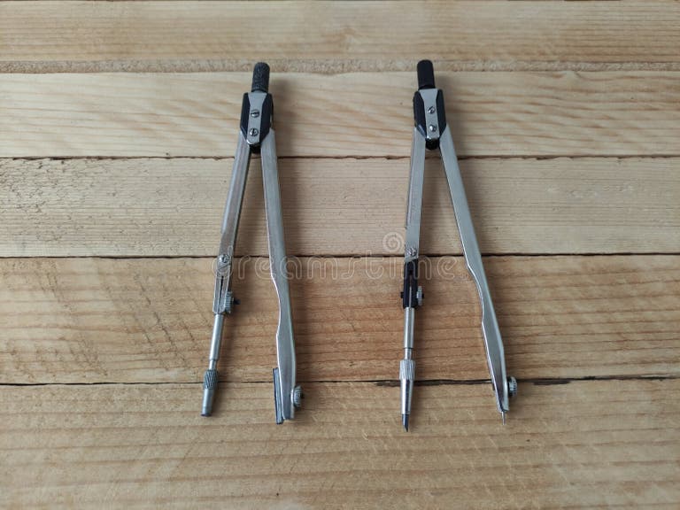 Two Drawing Compasses on the Wooden Background Stock Photo - Image of ...