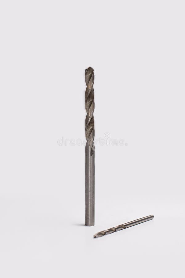 Two Drill Bits. a Large Drill Stands, and a Small One Lies Side by Side ...