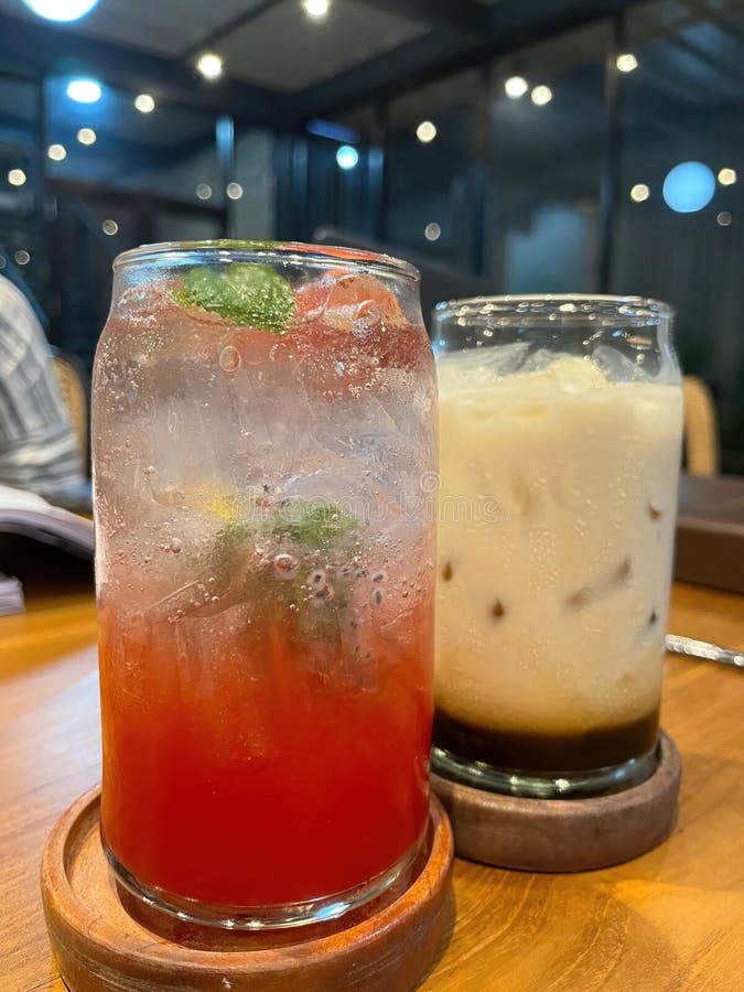 Two Drinks on a Table, One is a Pink Drink and the Other is a White ...