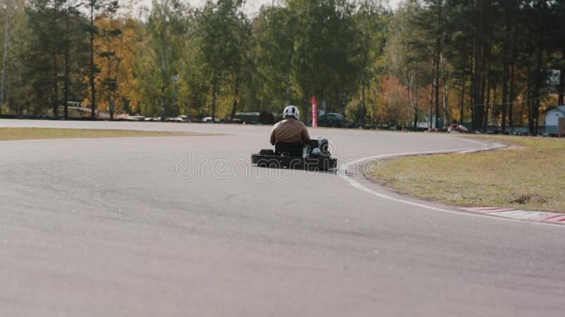 Two Drivers on a Go-kart Track Pass by the Camera. Go-kart Race. Stock ...