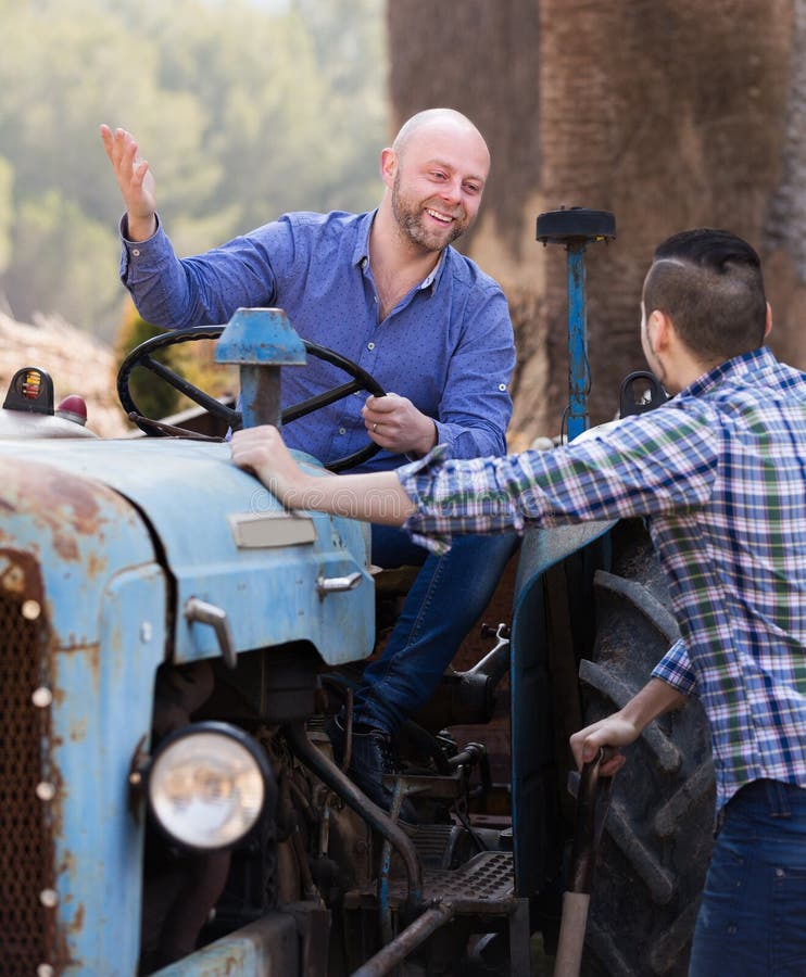Two Drivers Working with Tractor Stock Photo - Image of outdoor ...