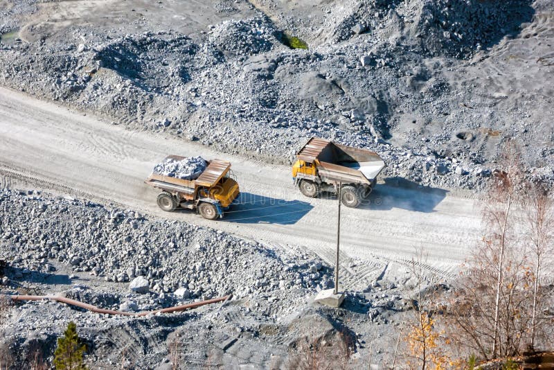 Two Quarry Dump Trucks at the Bottom of a Stone Pit Stock Image - Image ...