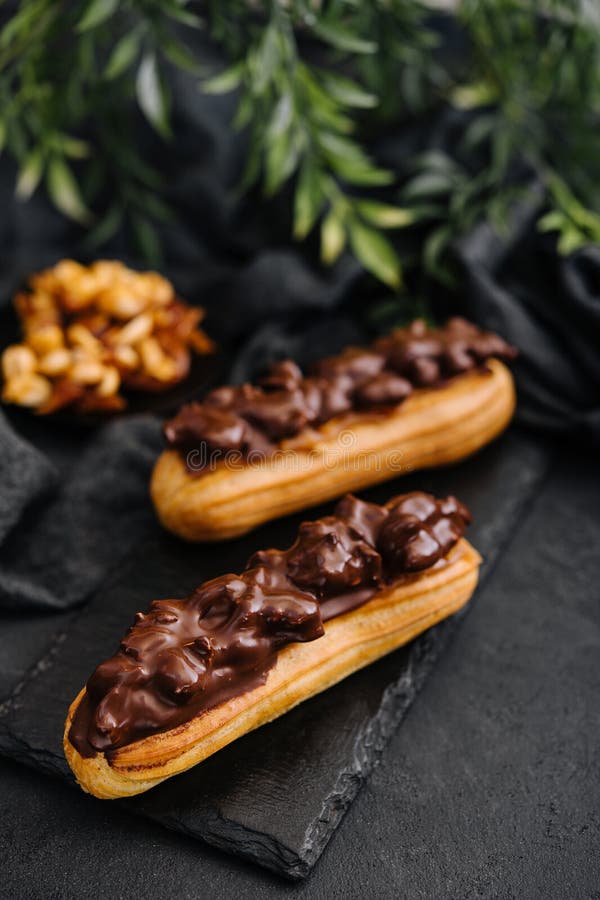 Two Eclairs with Dark Chocolate Stock Photo - Image of breakfast, slate ...