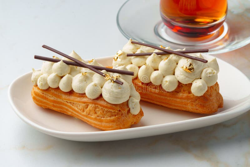 Two Eclairs with White Custard on Whhite Plate Close Up Stock Image ...