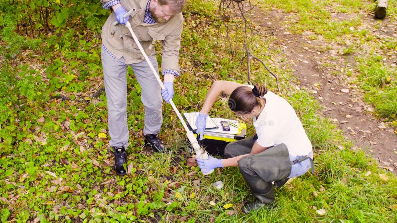 Two Ecologist Getting Samples of Soil in City Park Stock Photo - Image ...