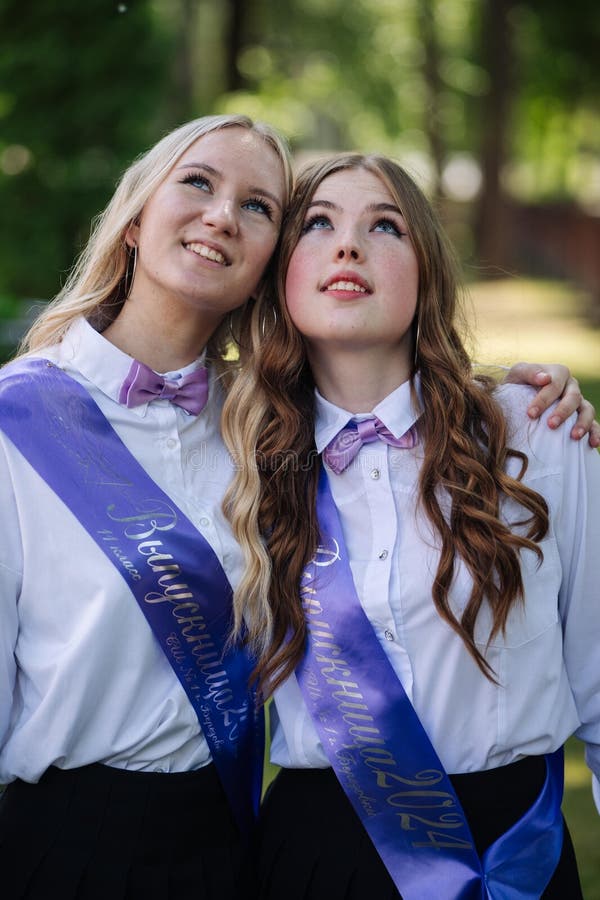Two Ecstatic Graduates in Sashes Gaze at the Sky, Rejoicing in the ...