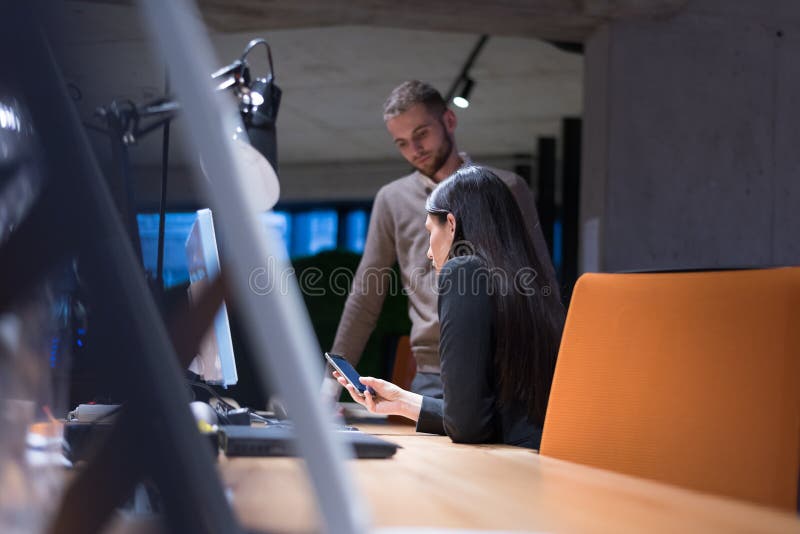 Two Focused Young Business Colleagues Talking about a New Project while ... Two Focused Young Business Colleagues Talking about a New Project while ...