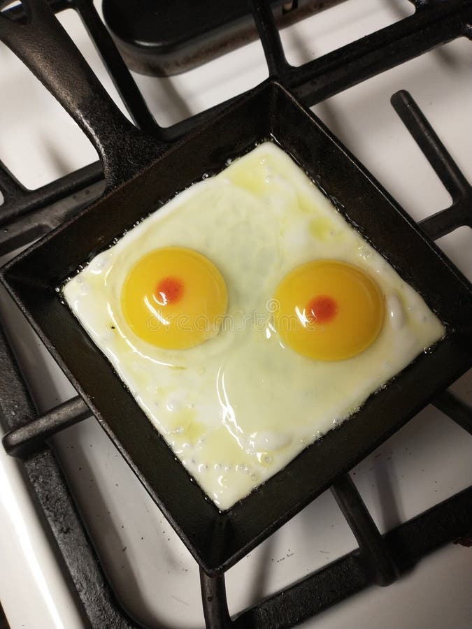 Two Eggs in a Square Pan with Sriracha Stock Image - Image of skillet ...