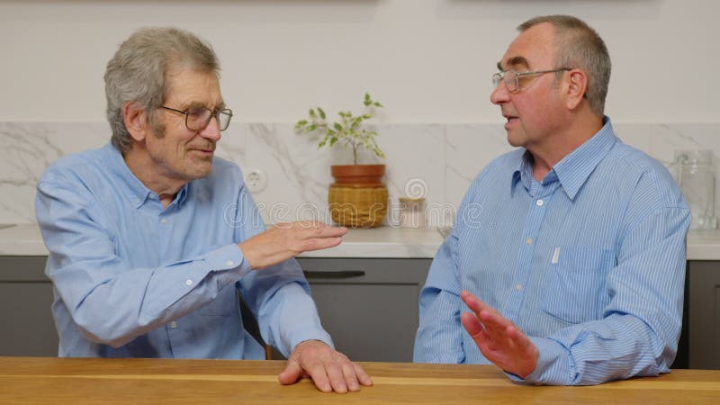 Two Elderly Men are Talking at the Table. Elderly Communication Concept ...