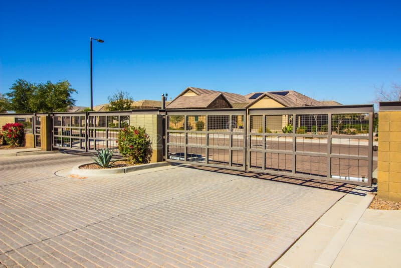 Two Electric Entry/Exit Gates with Brick Driveway Stock Photo - Image ...