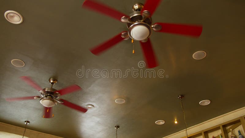 Two Electric Fans Spin on the Ceiling in a Cafe, Camera Movement Stock ...