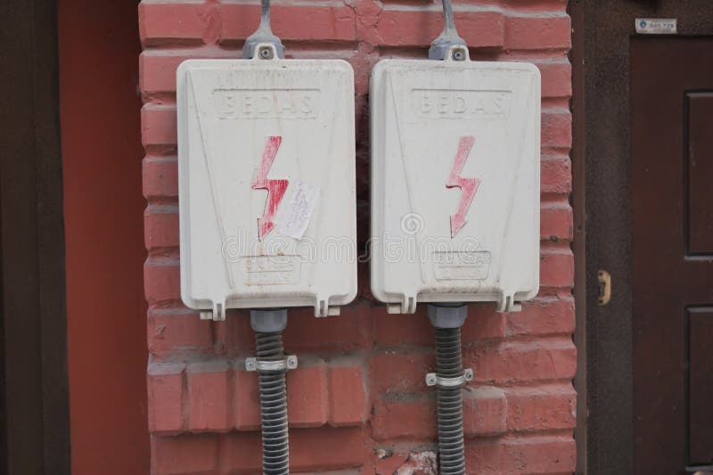 Two Electrical Boxes with Lightning Bolt on Brick Wall Stock Photo ...