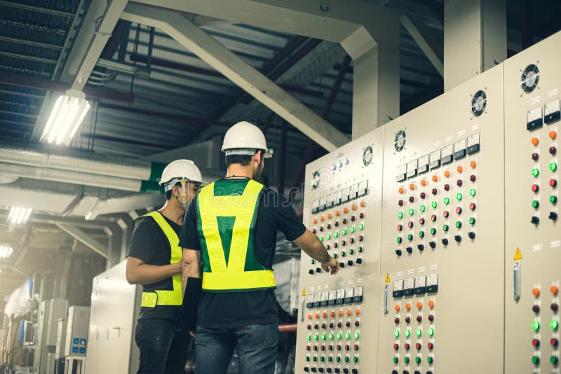 Two Electrical Engineer Team Working Front Control Panel. Stock Image ...