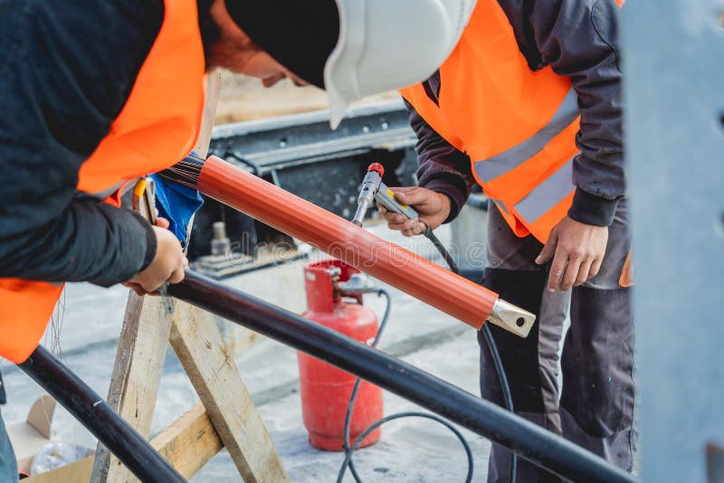 Two Electrician Builder Workers Installing High-voltage Cable Stock ...