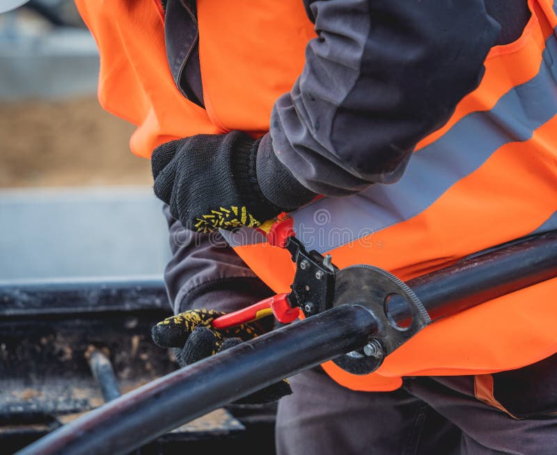 Two Electrician Builder Workers Installing High-voltage Cable Stock ...