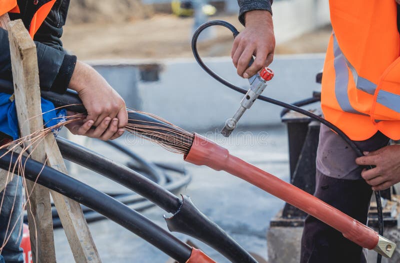 Two Electrician Builder Workers Installing High-voltage Cable Stock ...