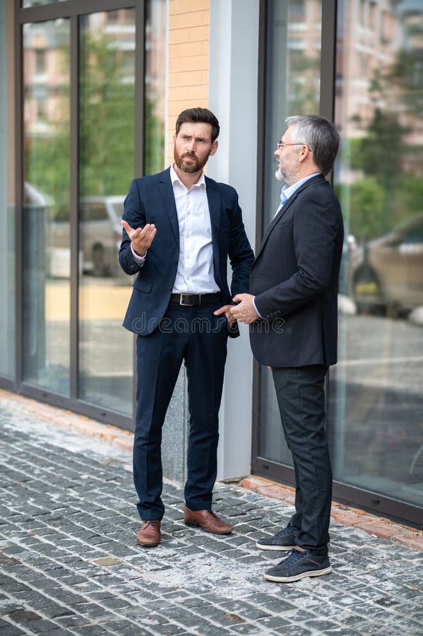 Two Elegant Men Talking and Looking Interested Stock Image - Image of ...