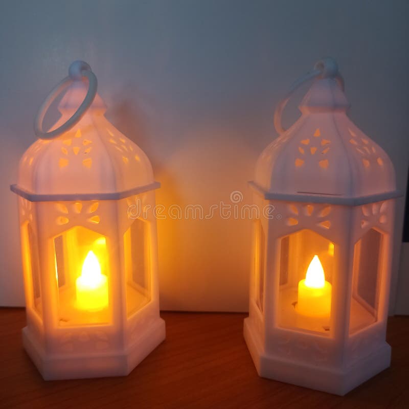 Two Elegant White Lanterns, Illuminated by Warm Candlelight, Cast a ...