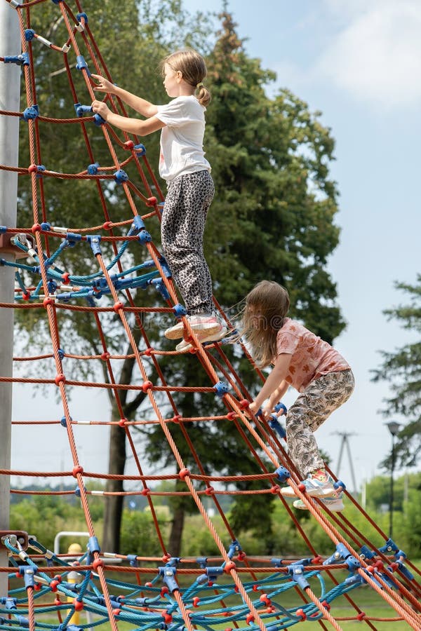 Two Elementary School Age Kids, Children Climbing a Tall Structure at ...