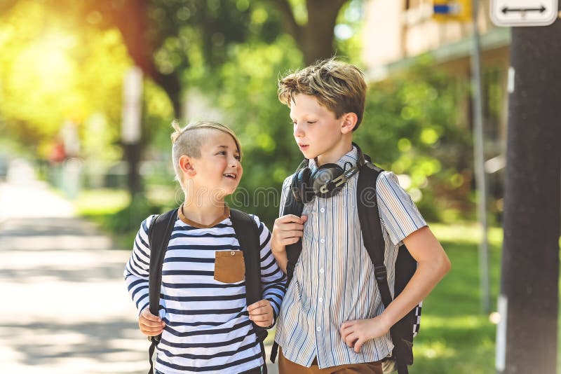 Two Elementary School Boys Outside Carrying a Backpack Stock Image ...